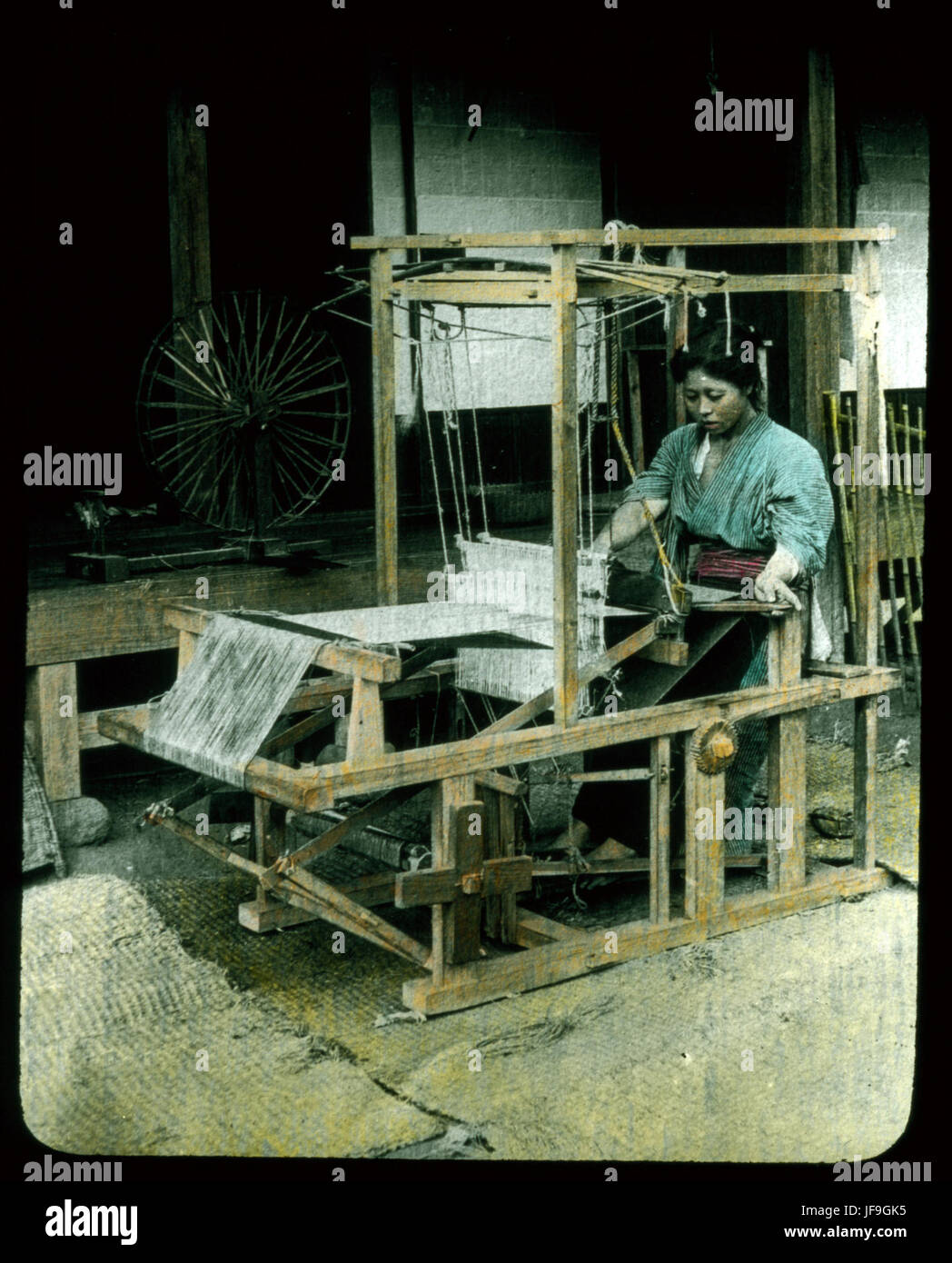 A detailed photograph showing the art of silk weaving on a hand loom ...