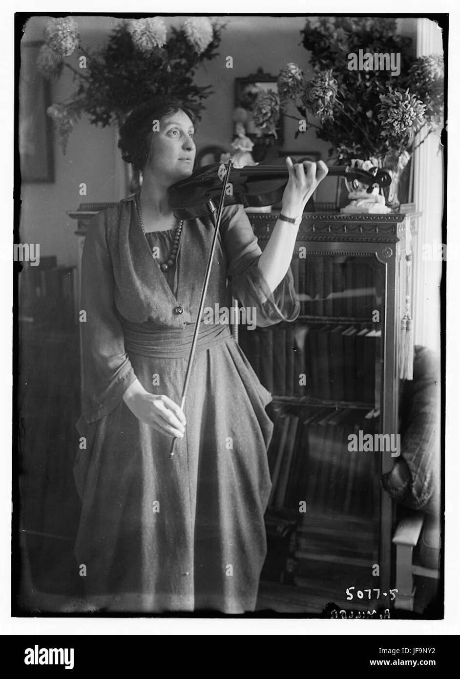 A portrait of R. Miller playing the violin, capturing a moment of ...