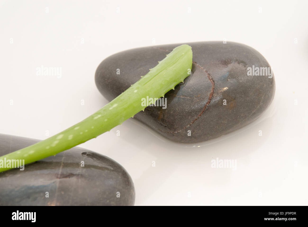 Spa treatment background of pebbles and running water Stock Photo - Alamy