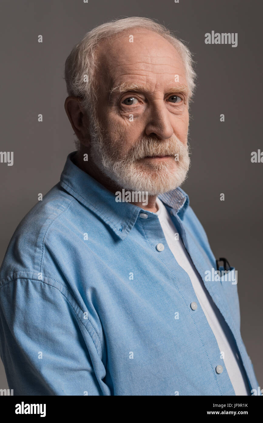 portrait of senior bearded man isolated on grey in studio Stock Photo ...