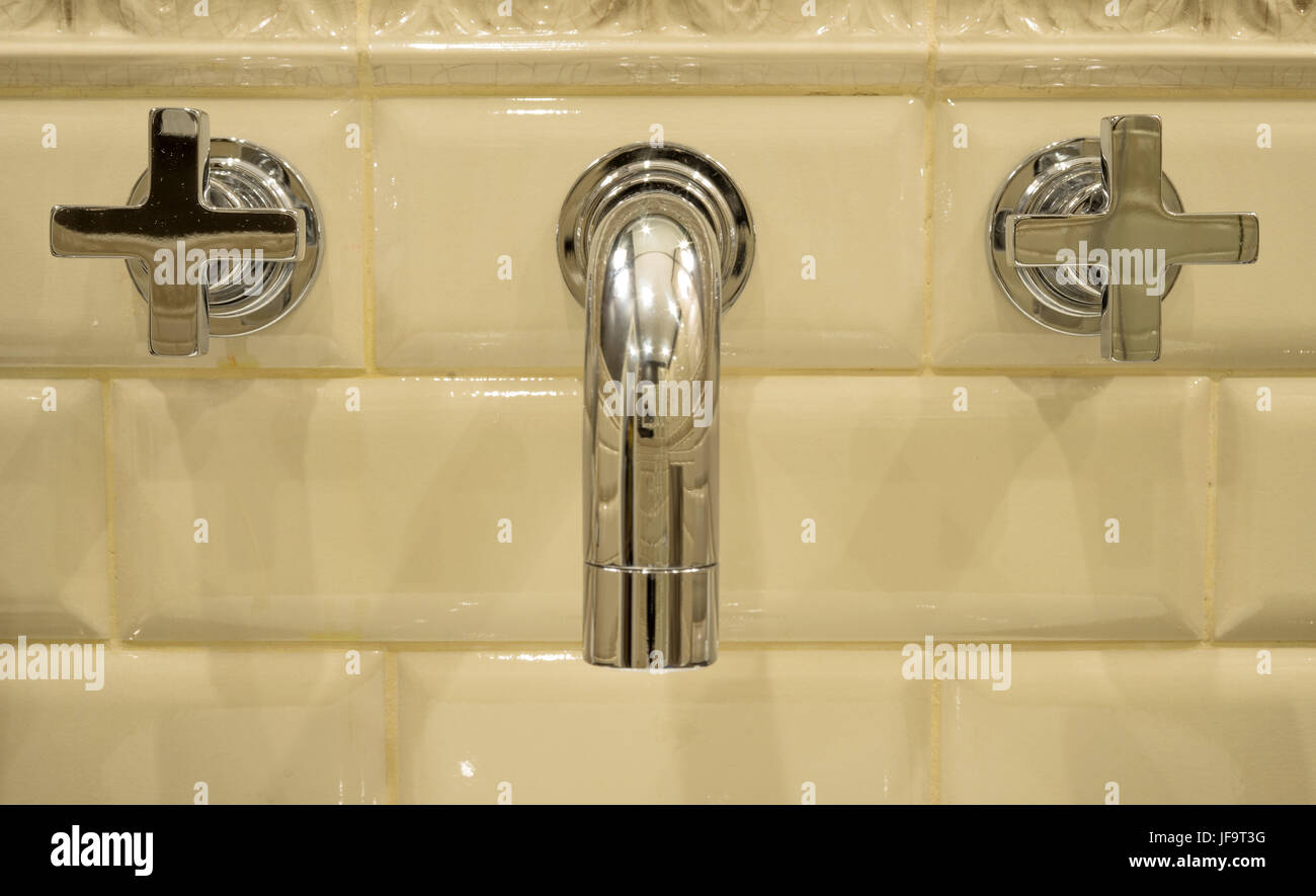 Water tap mounted in the wall Stock Photo - Alamy