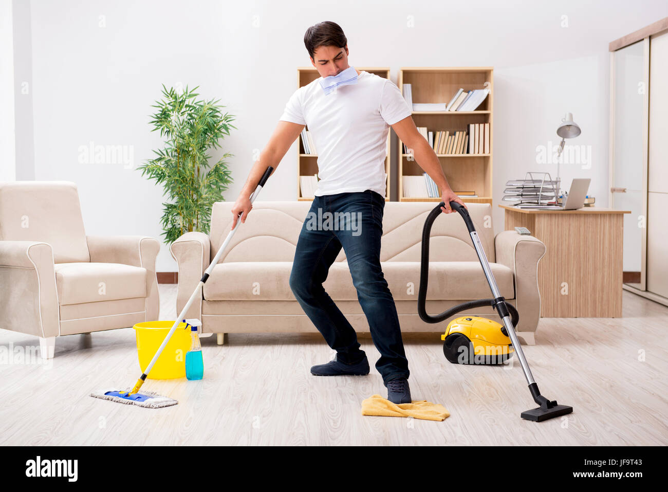 Man cleaning home with vacuum cleaner Stock Photo - Alamy
