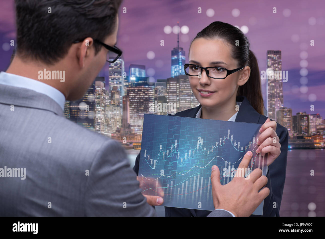 Business people discussing stock chart trends Stock Photo - Alamy