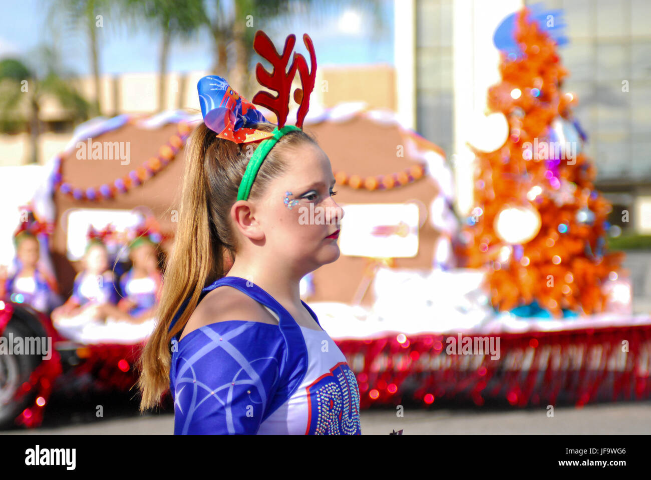Girl dressed in christmas costume looking sad marching in holiday ...