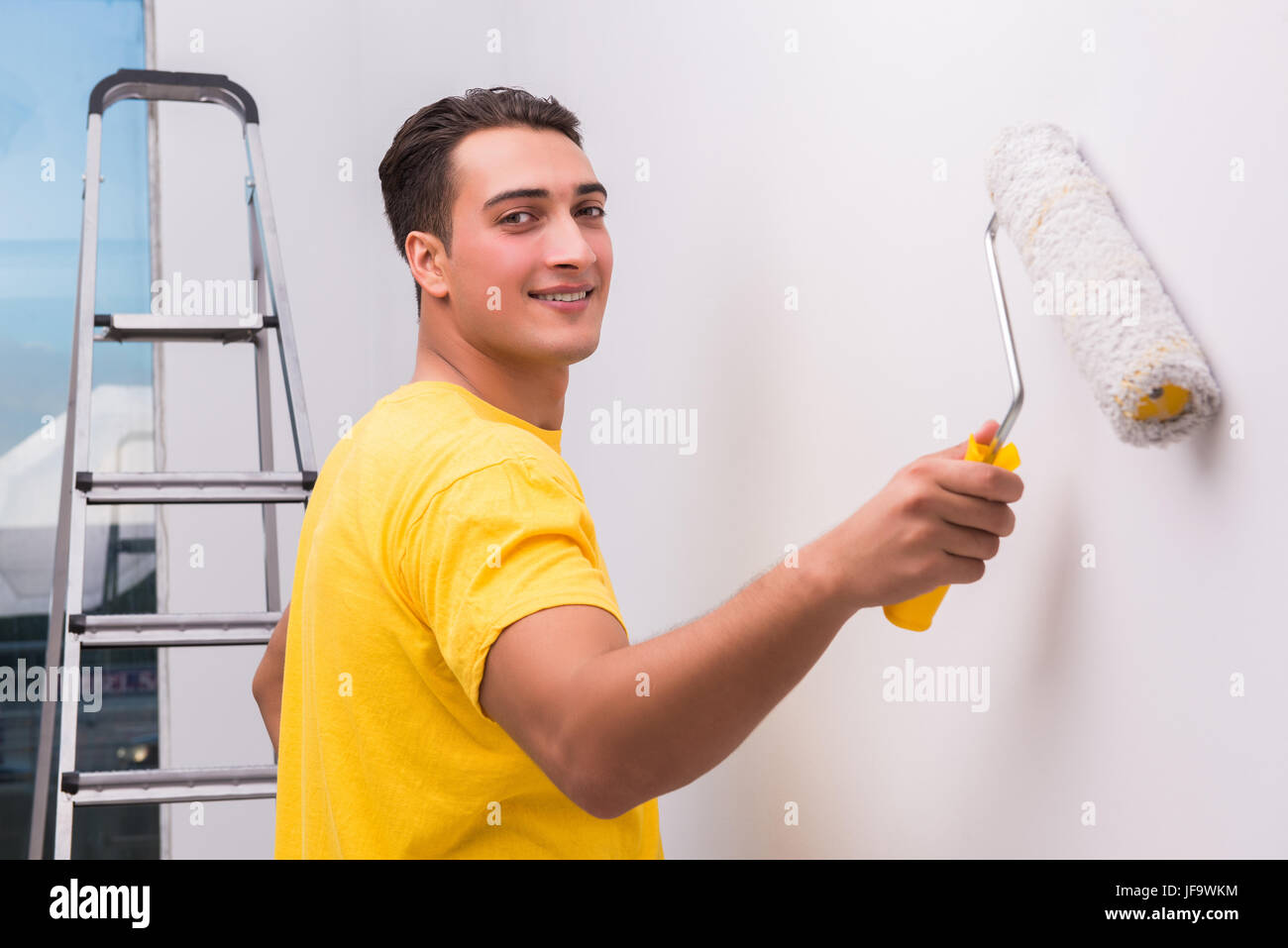 Man painting house in DIY concept Stock Photo - Alamy