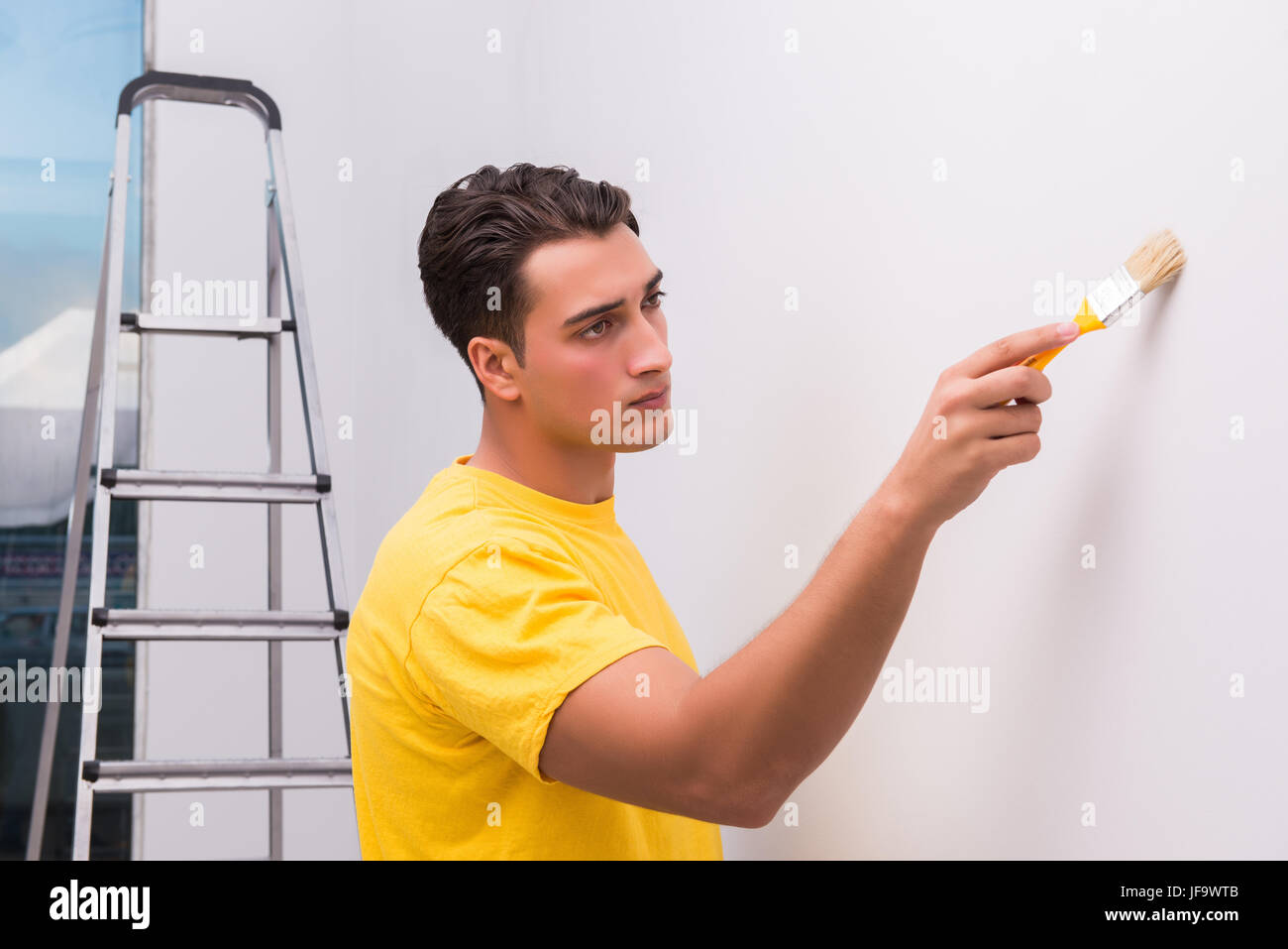 Man painting house in DIY concept Stock Photo - Alamy