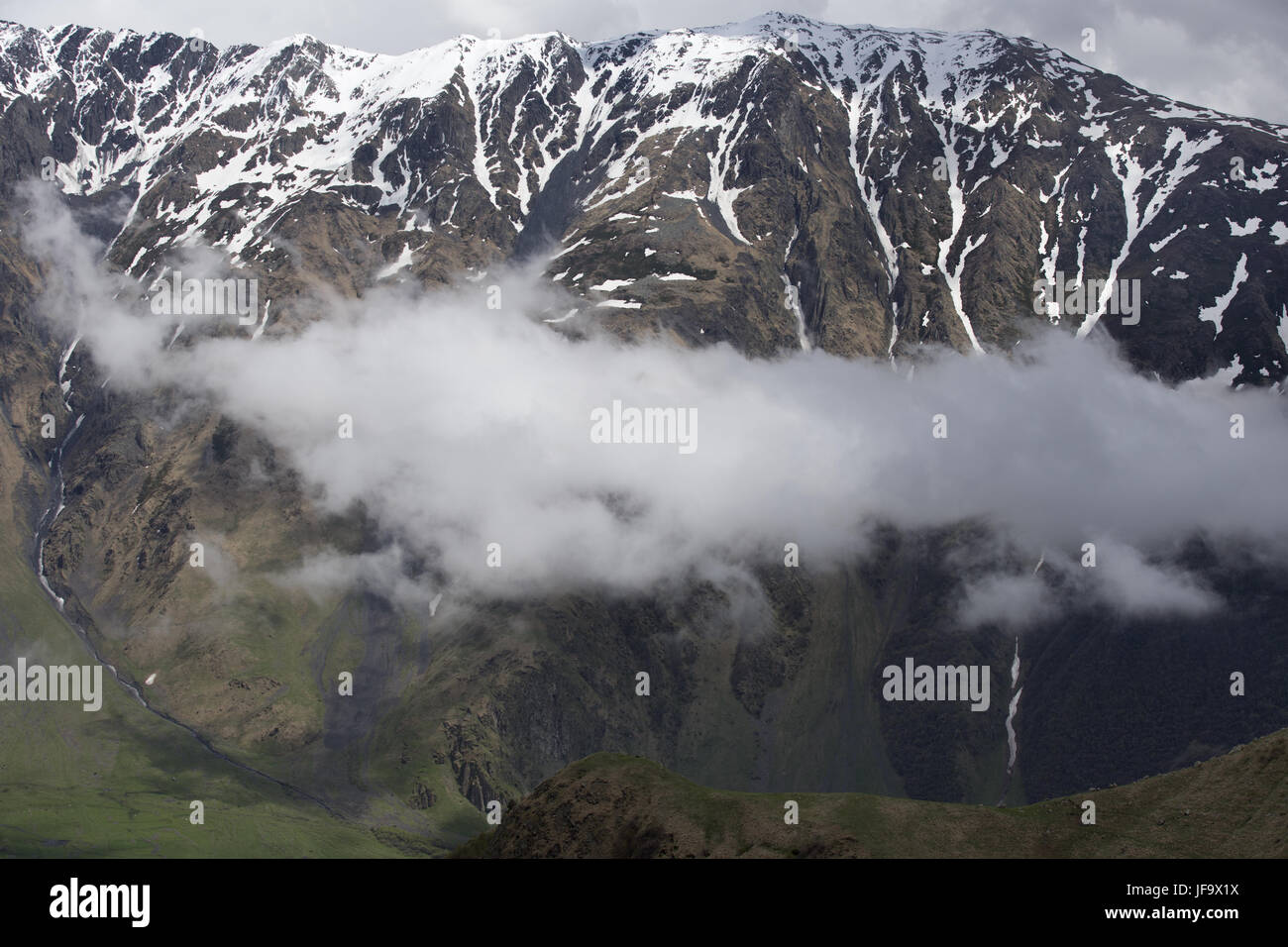 Clouds Flying Between Mountains Stock Photo - Alamy