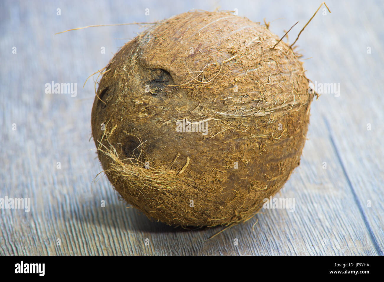 Coconut laying on wooden table Stock Photo - Alamy