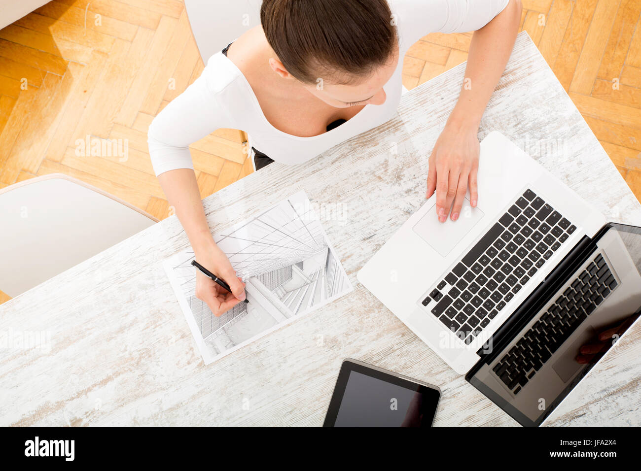 Woman drawing a blueprint Stock Photo - Alamy