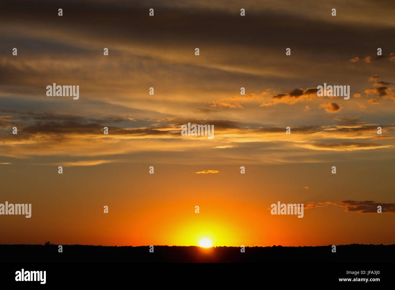 Bright landscape with the setting sun Stock Photo - Alamy