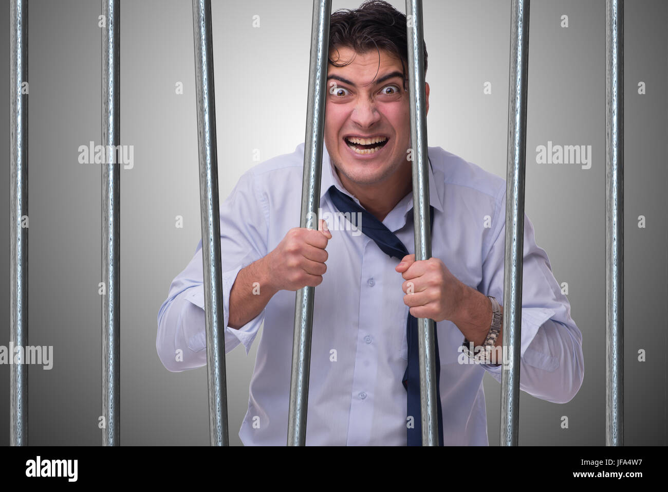 Young businessman behind the bars in prison Stock Photo - Alamy