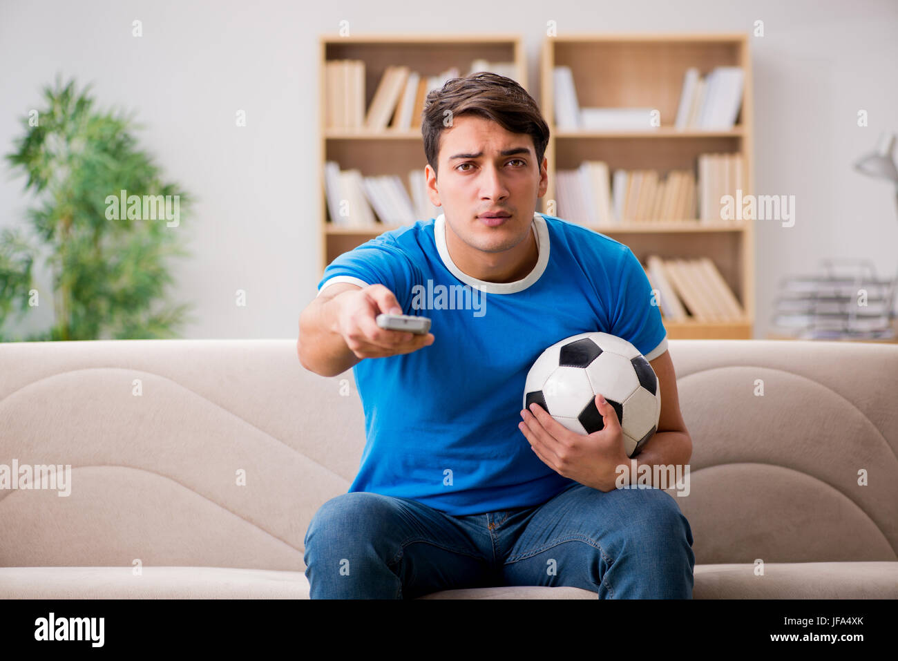 Man watching football at home Stock Photo - Alamy