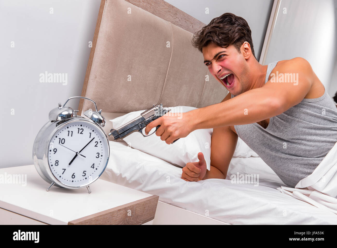 Angry man with gun and clock Stock Photo - Alamy