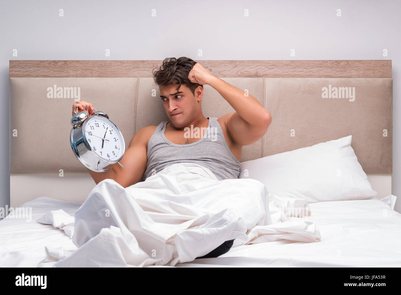 Man having trouble waking up in the morning Stock Photo - Alamy
