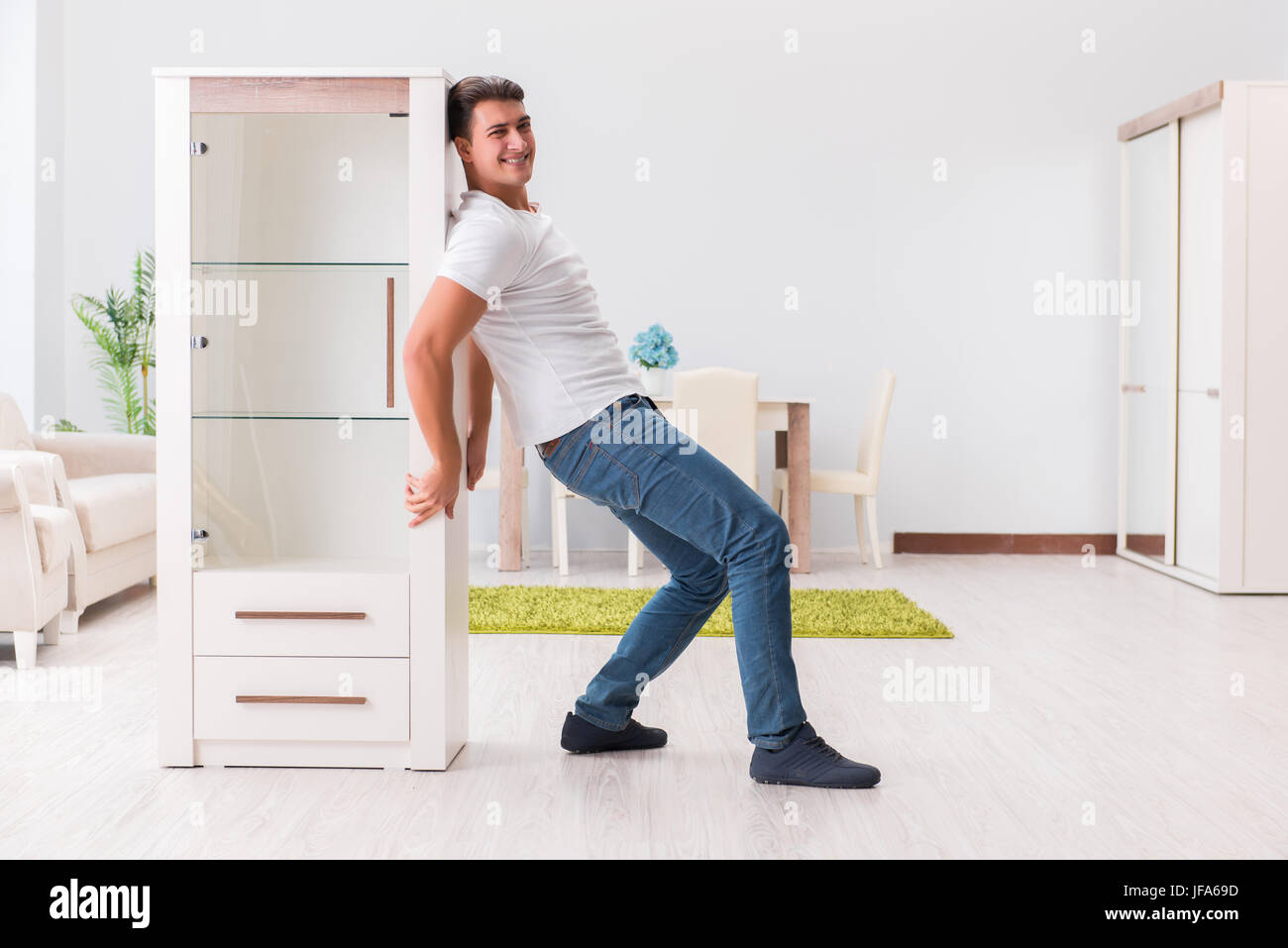Man moving furniture at home Stock Photo - Alamy