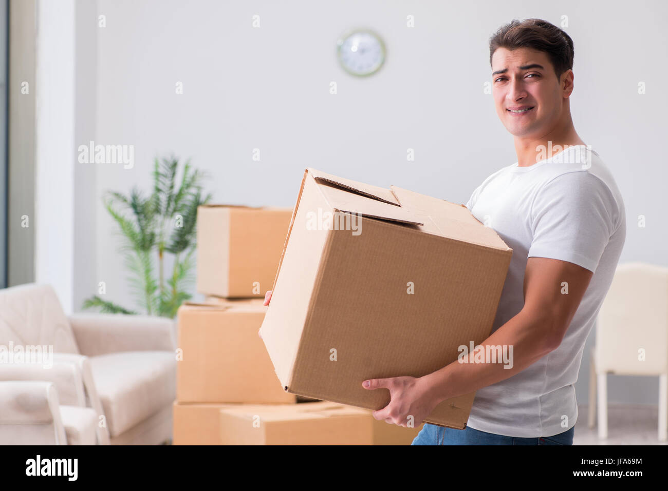 Tired delivery man with box Stock Photo - Alamy