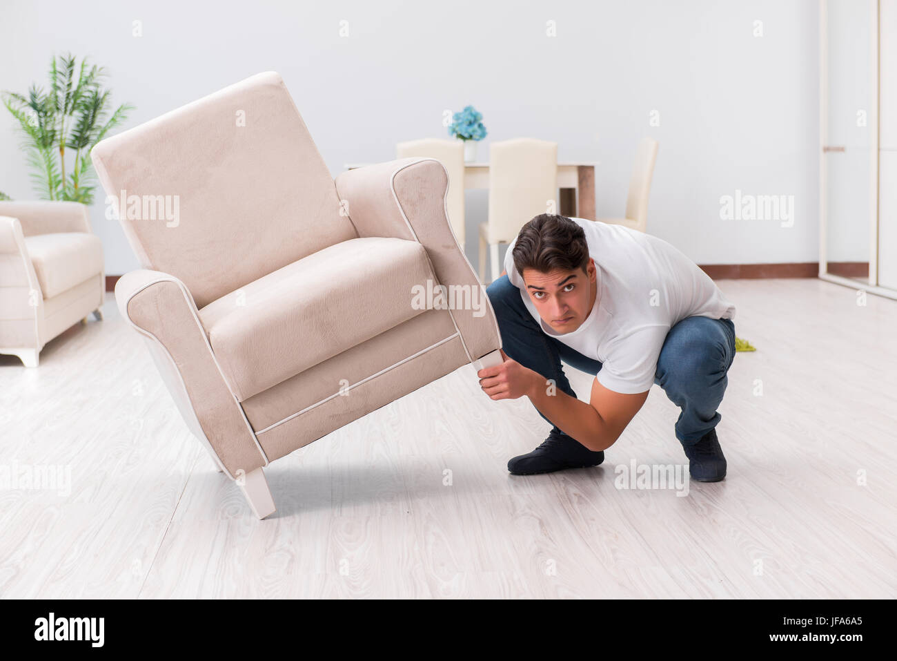 Man moving furniture at home Stock Photo - Alamy
