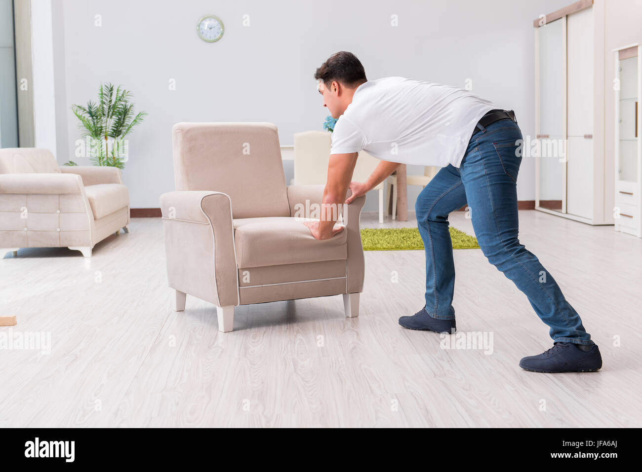 Man moving furniture at home Stock Photo - Alamy