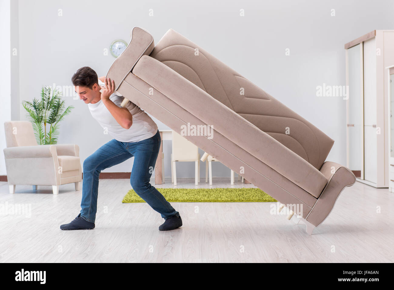 Man moving furniture at home Stock Photo - Alamy