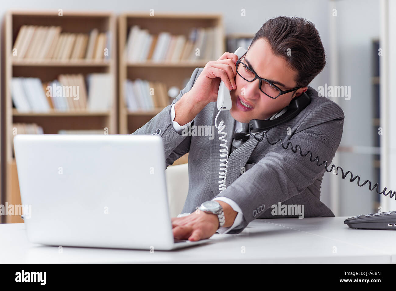 Angry helpdesk operator in the office Stock Photo - Alamy