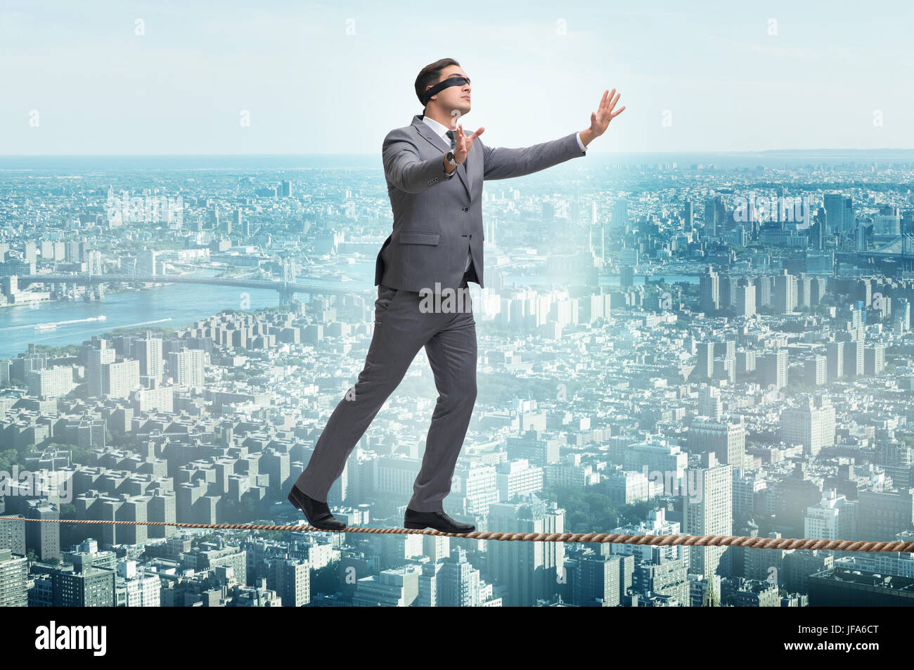 Man walking in tight rope blindfold Stock Photo - Alamy