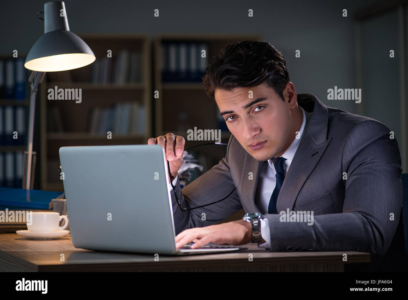 Man staying in the office for long hours Stock Photo - Alamy