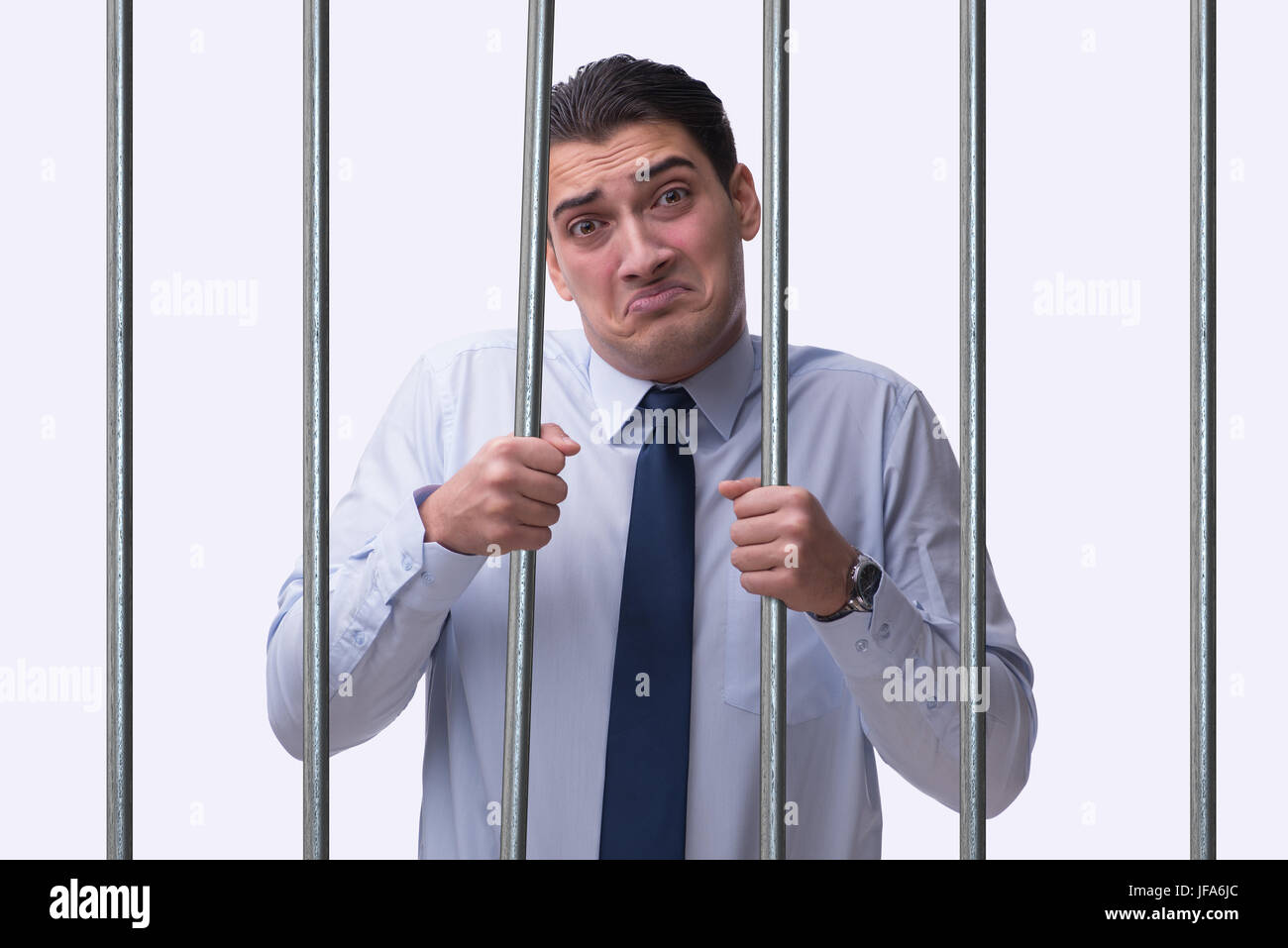 Young businessman behind the bars in prison Stock Photo - Alamy