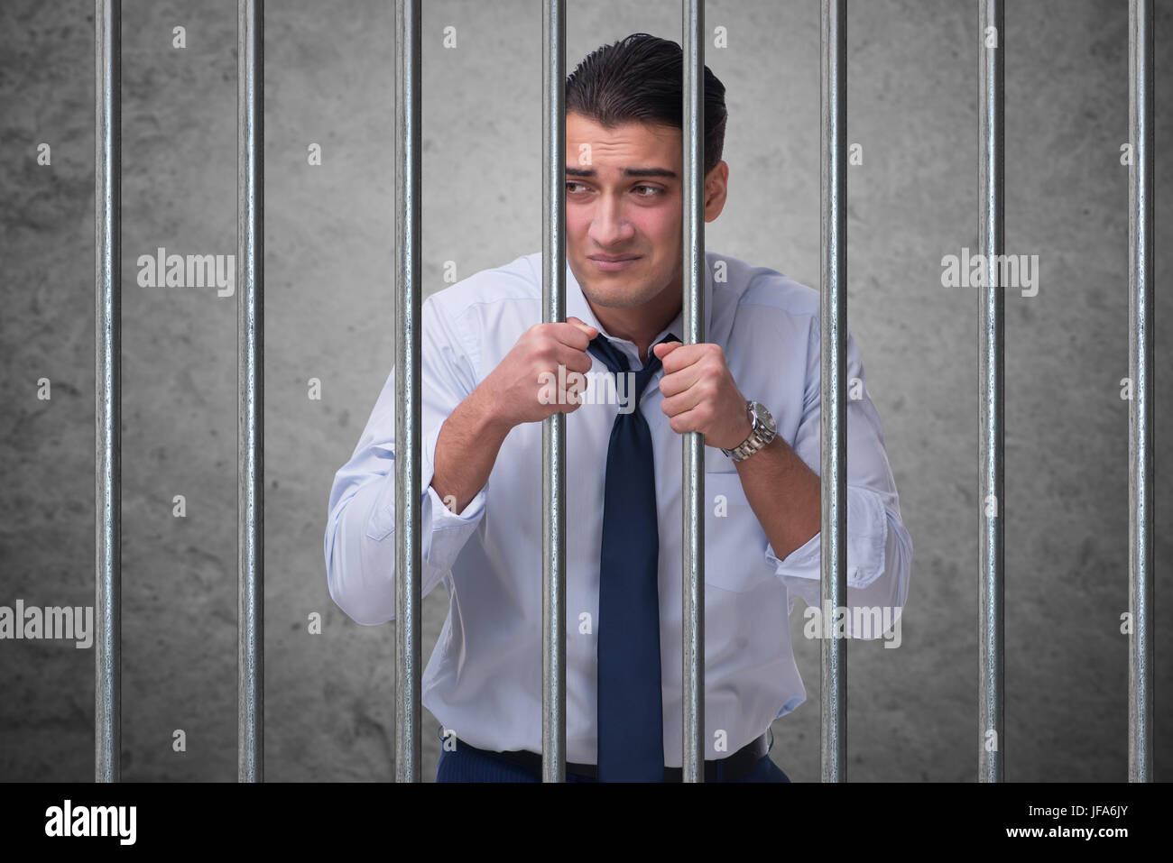 Young businessman behind the bars in prison Stock Photo - Alamy