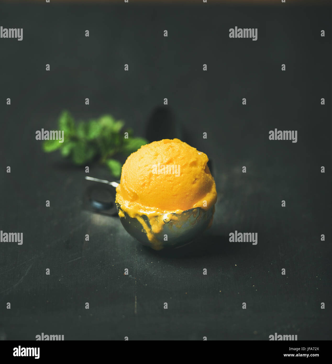 Mango sorbet ice cream scoop, square crop, copy space Stock Photo - Alamy
