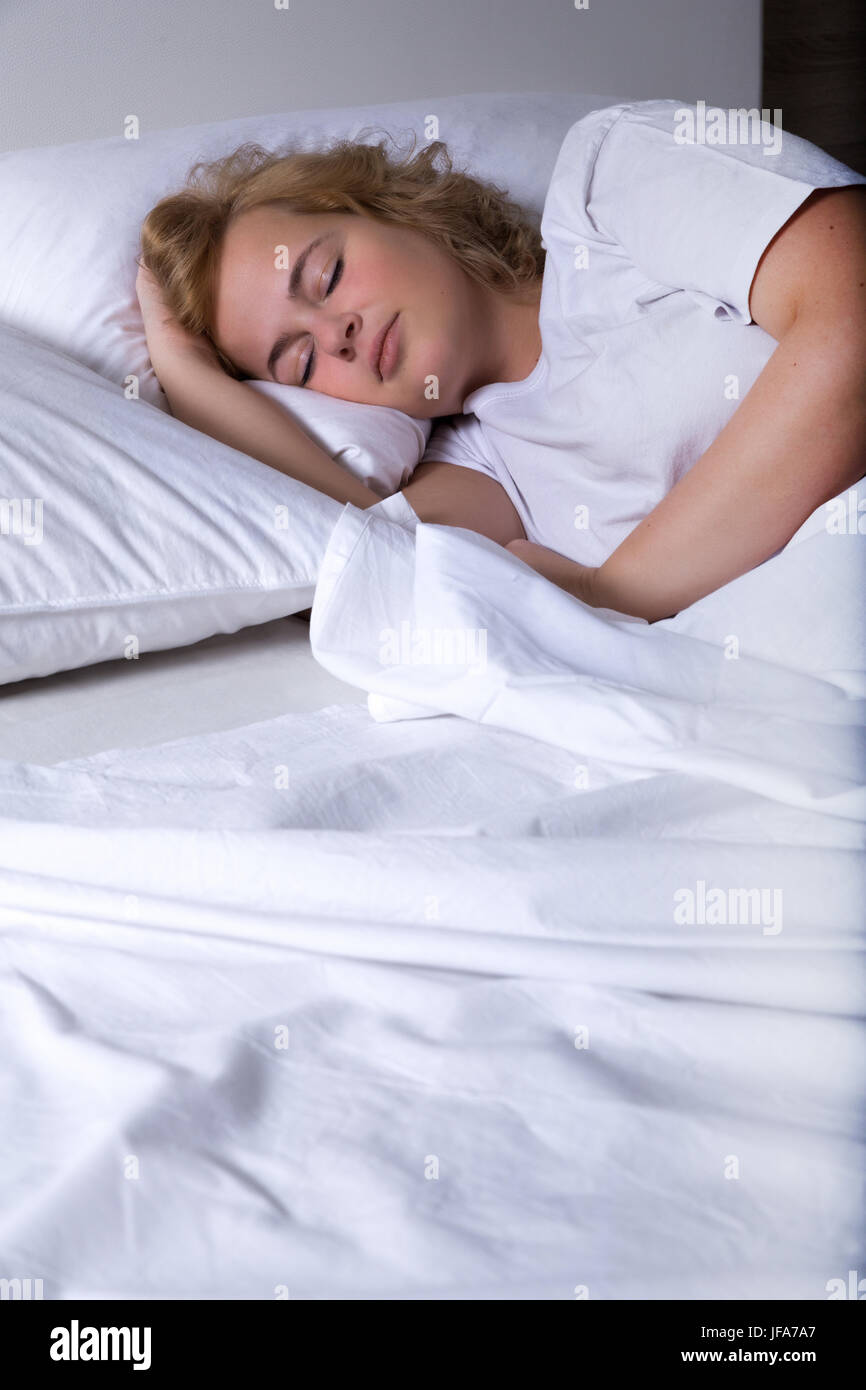 Young woman sleeping in Bed at night Stock Photo - Alamy