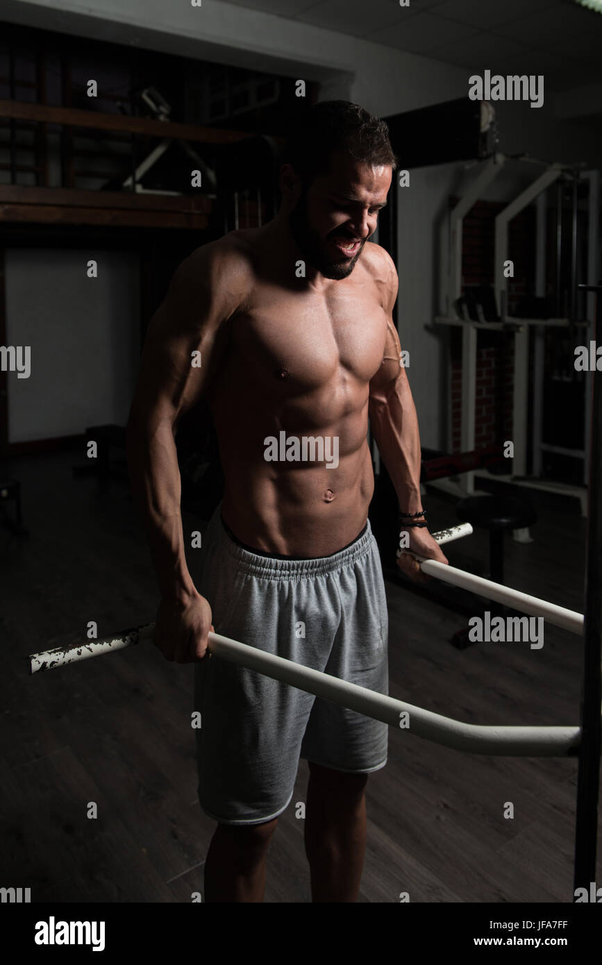 Model Doing Heavy Weight Exercise For Trapezius On Machine Stock Photo ...