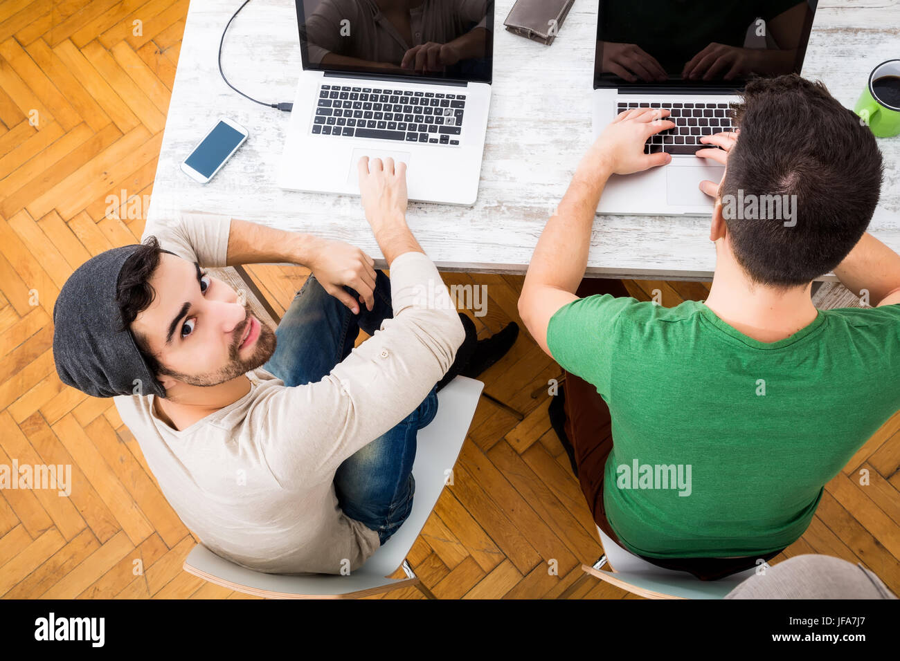 Two young men working in the office Stock Photo - Alamy