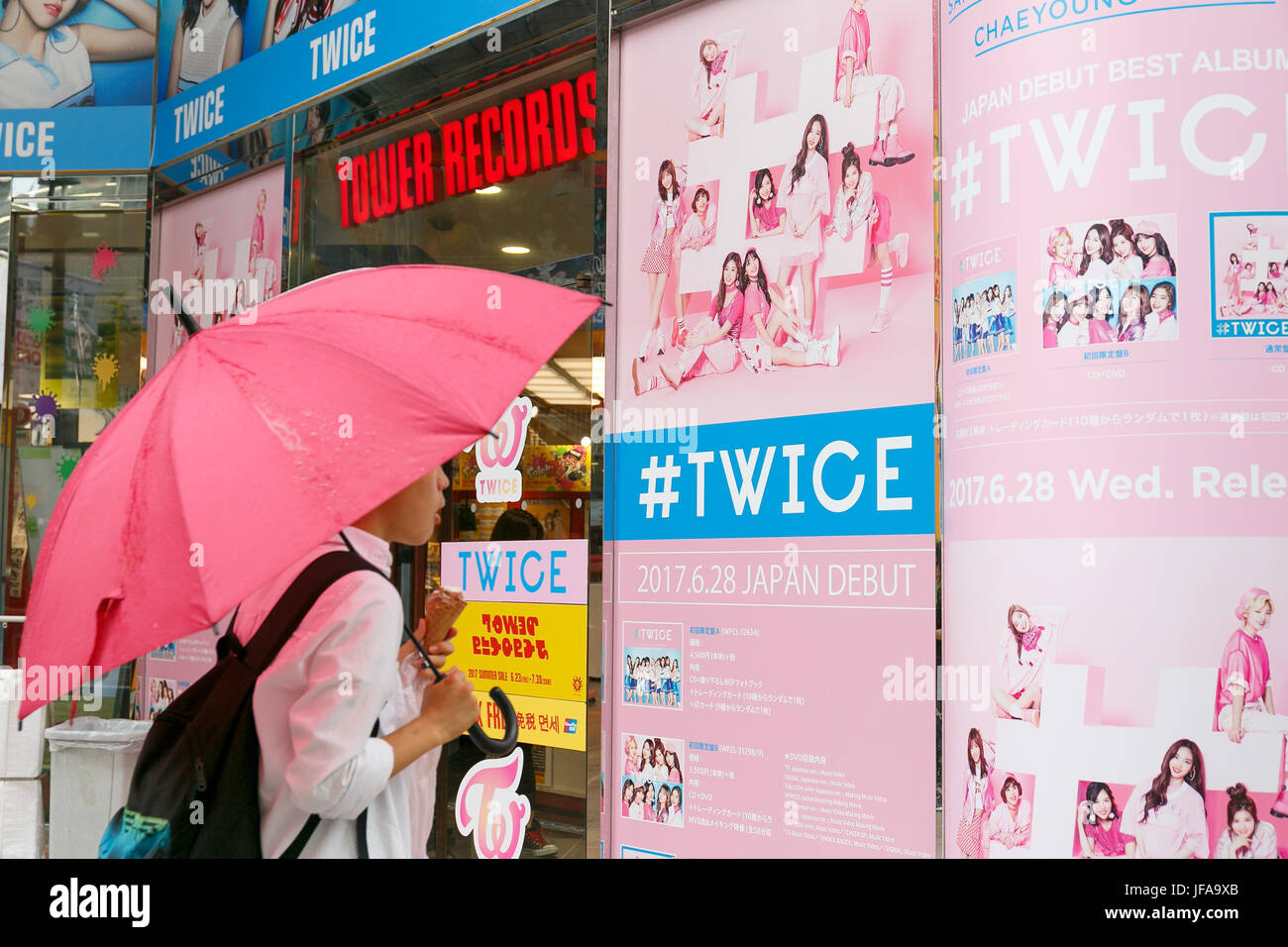 A man walks past advertisements for the new album #Twice on display ...