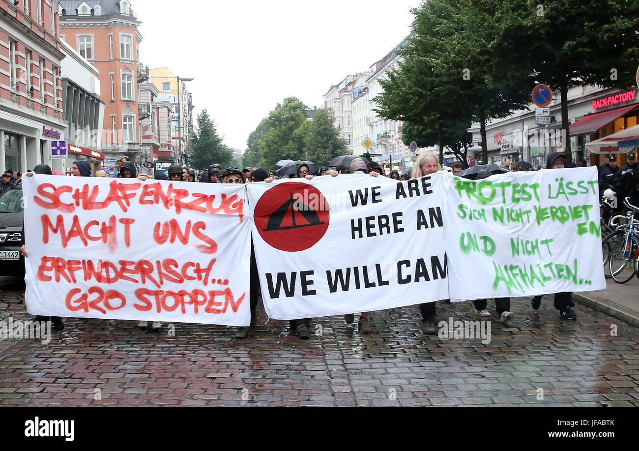 Demonstrators carry banners with the slogans 'Sleep deprivation makes ...