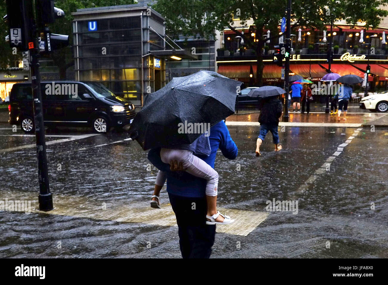 Berlin, Germany. 29th June, 2017. Tourists cross a flooded street in ...
