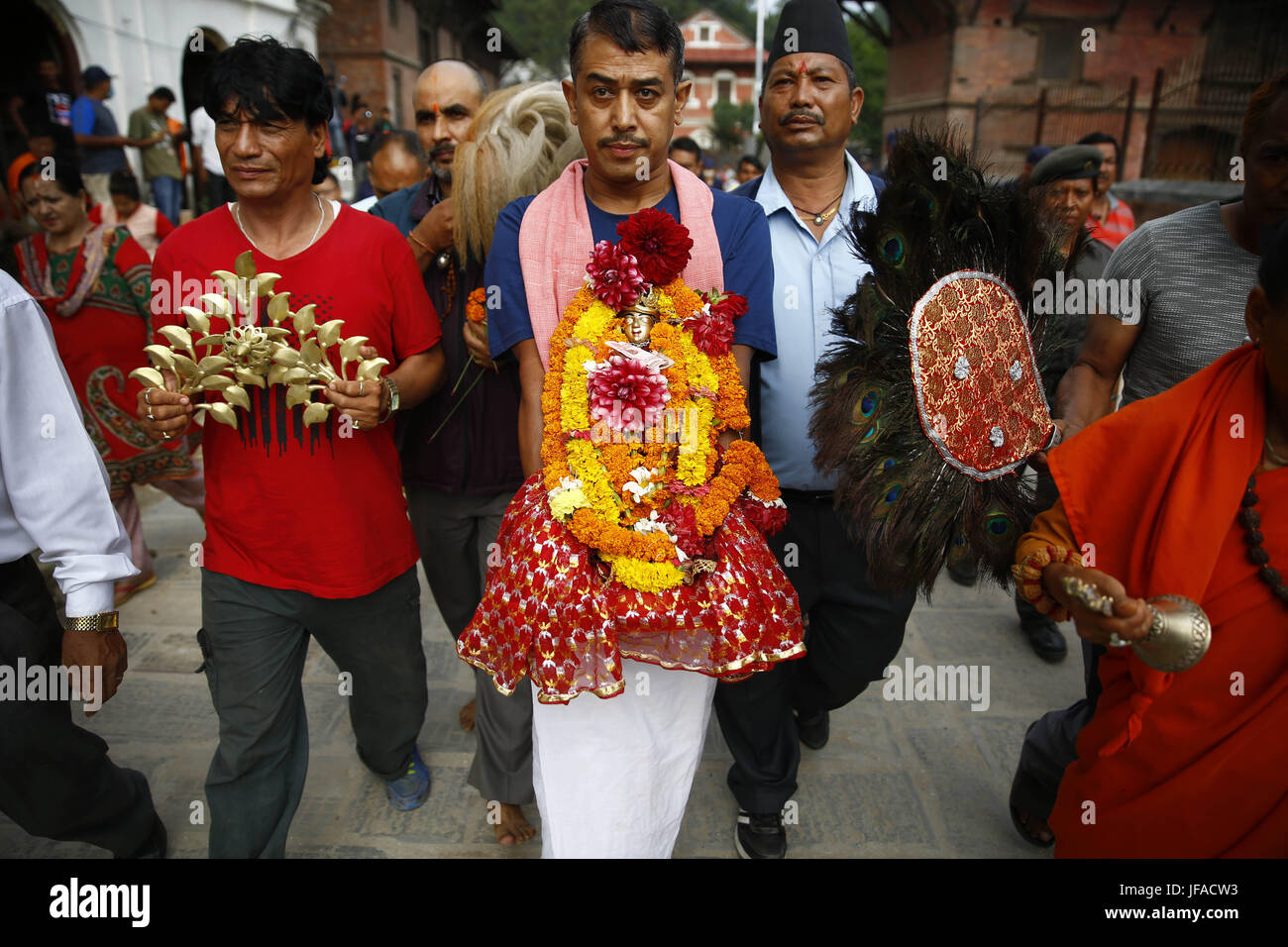 Kathmandu, Nepal. 30th June, 2017. A Nepalese priest carries an idol of ...