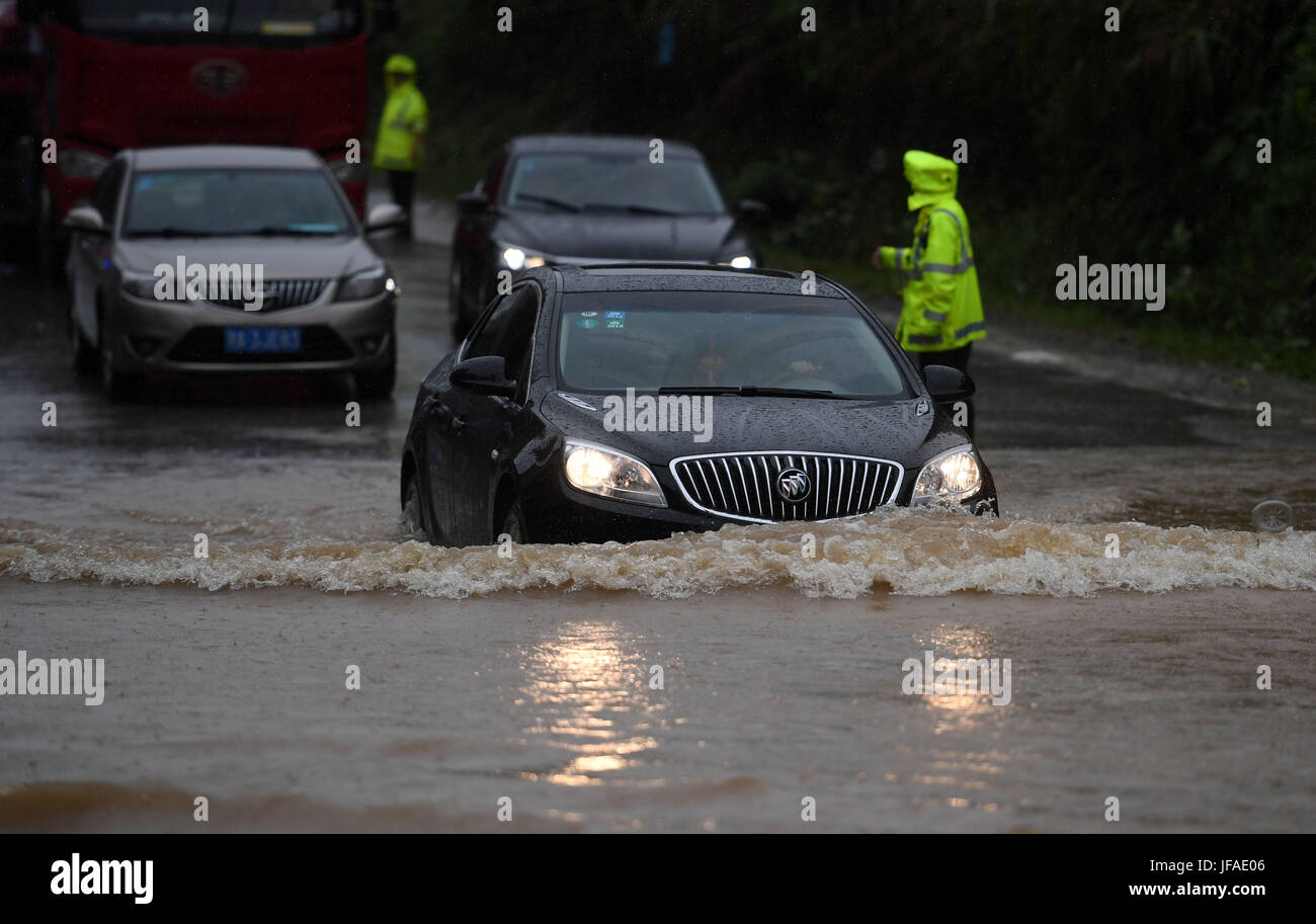 Anhua, China's Hunan Province. 30th June, 2017. Cars drive on a flooded ...