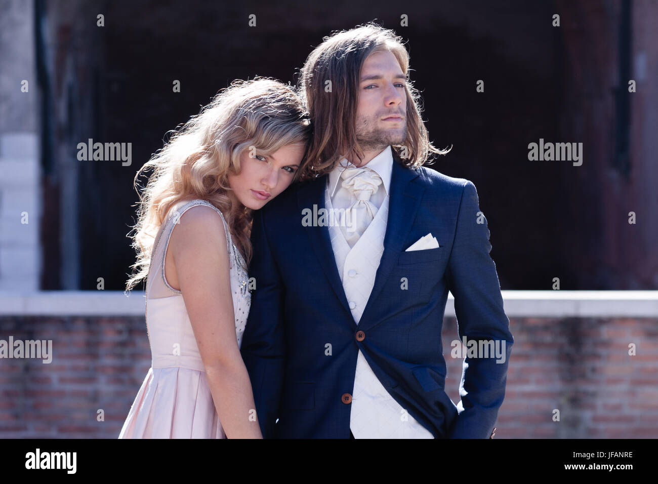 fashion models man and woman standing outdoor in backlight Stock Photo ...