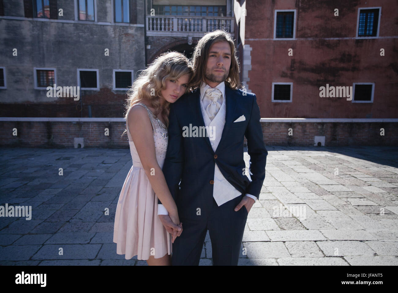fashion models man and woman standing outdoor in backlight Stock Photo ...