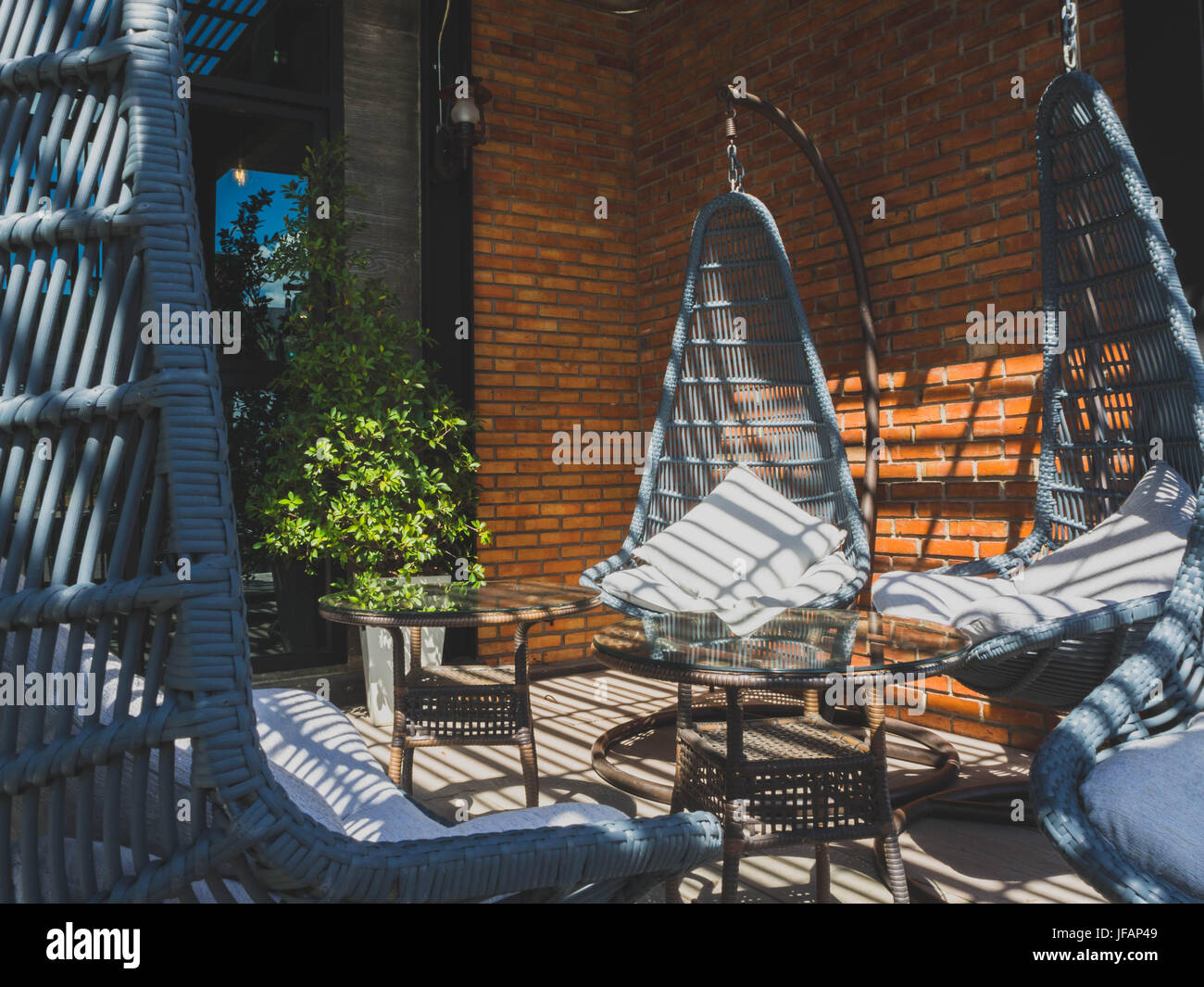 Hanging Wicker Chairs on the terrace Stock Photo - Alamy