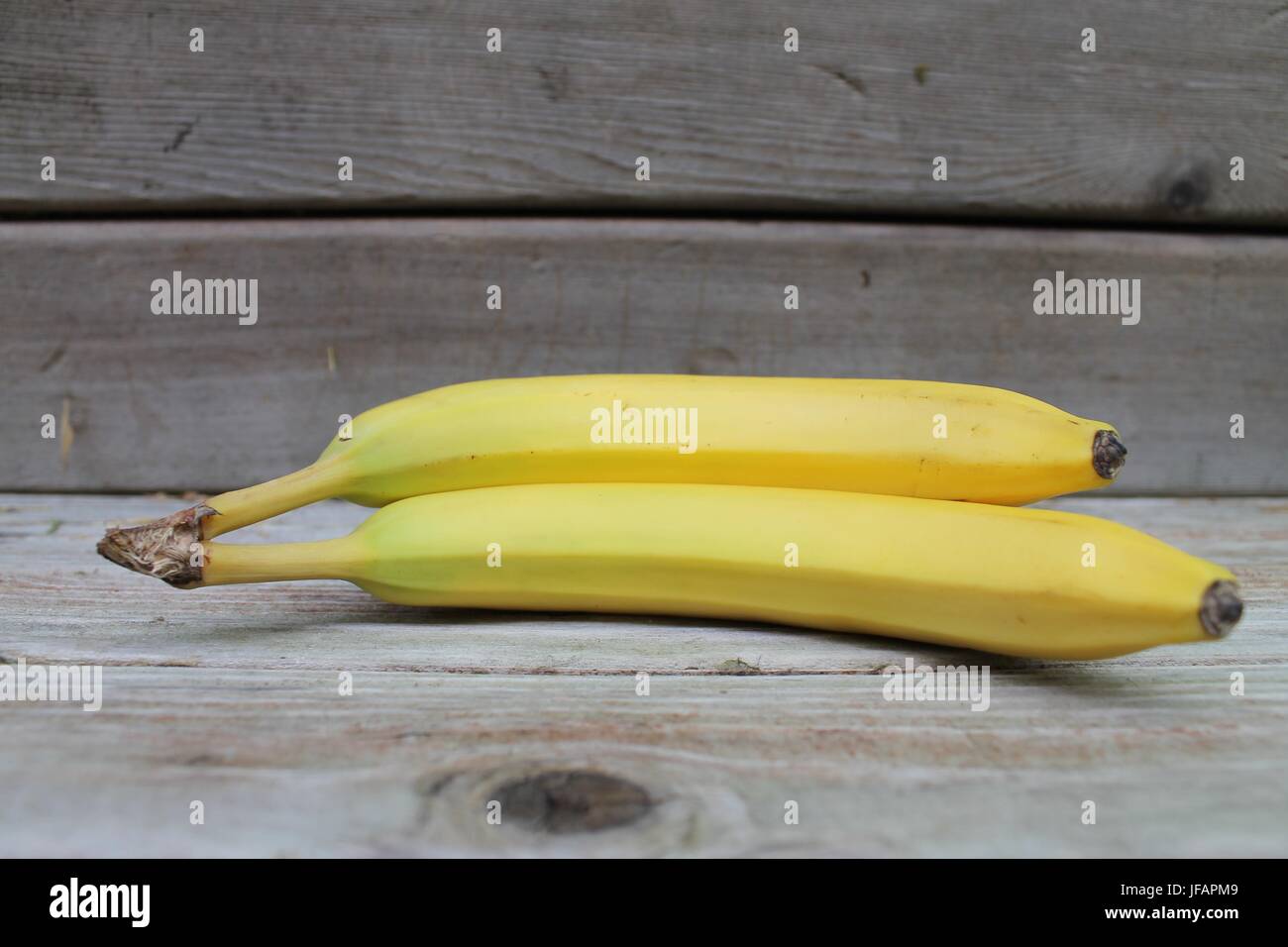 bananas on wood table Stock Photo - Alamy