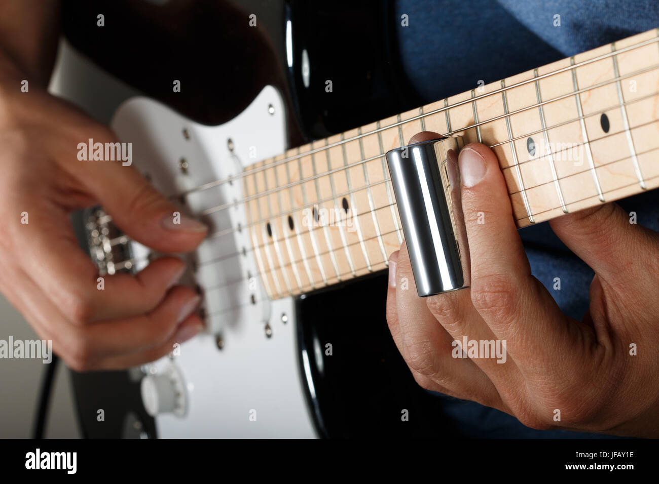 Electric guitar player performing song with slider Stock Photo - Alamy