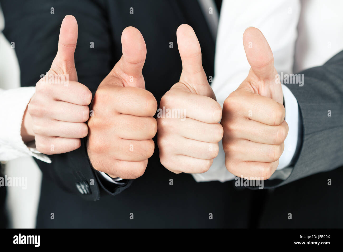 Business team pointing up their thumbs. of different business people ...