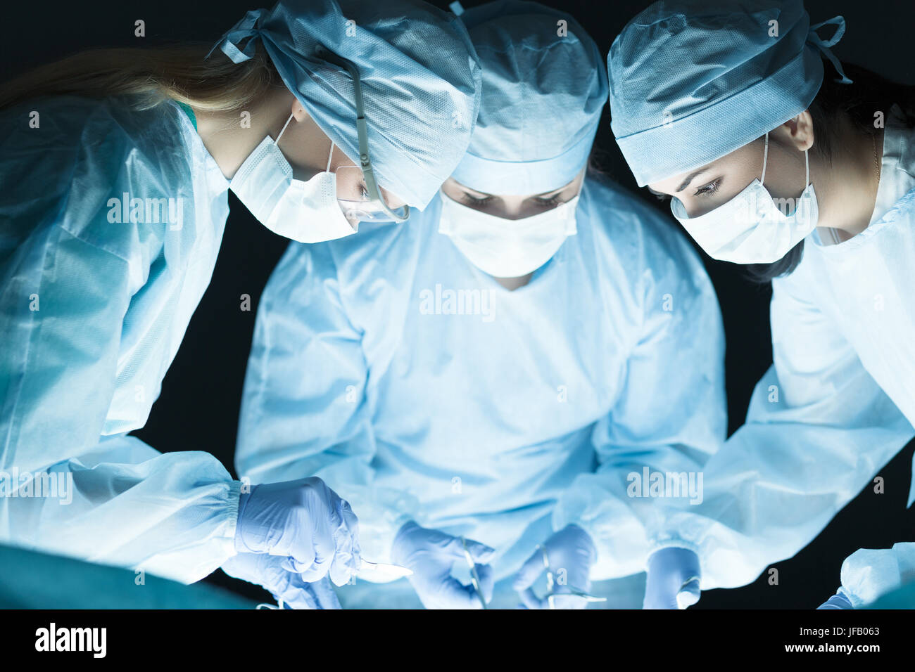 Medical team performing operation. Group of surgeon at work in ...