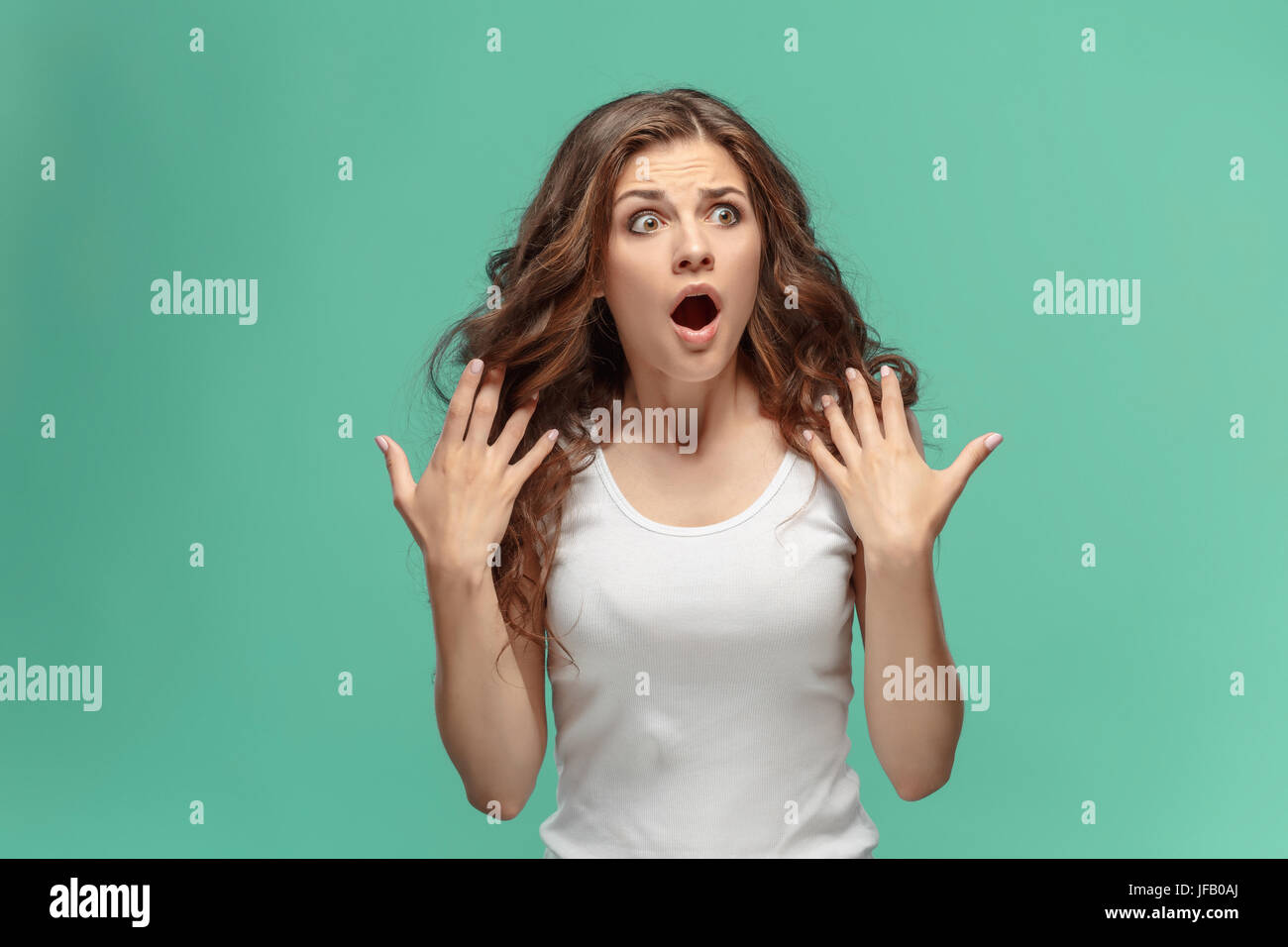 Portrait of young woman with shocked facial expression Stock Photo - Alamy