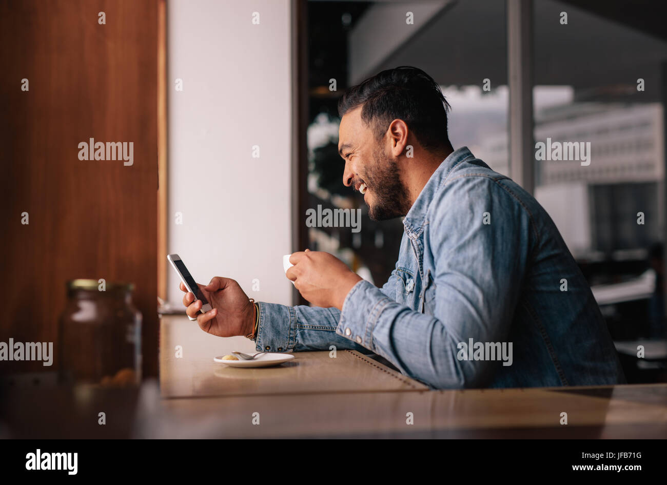Man sitting in coffee shop hi-res stock photography and images - Alamy