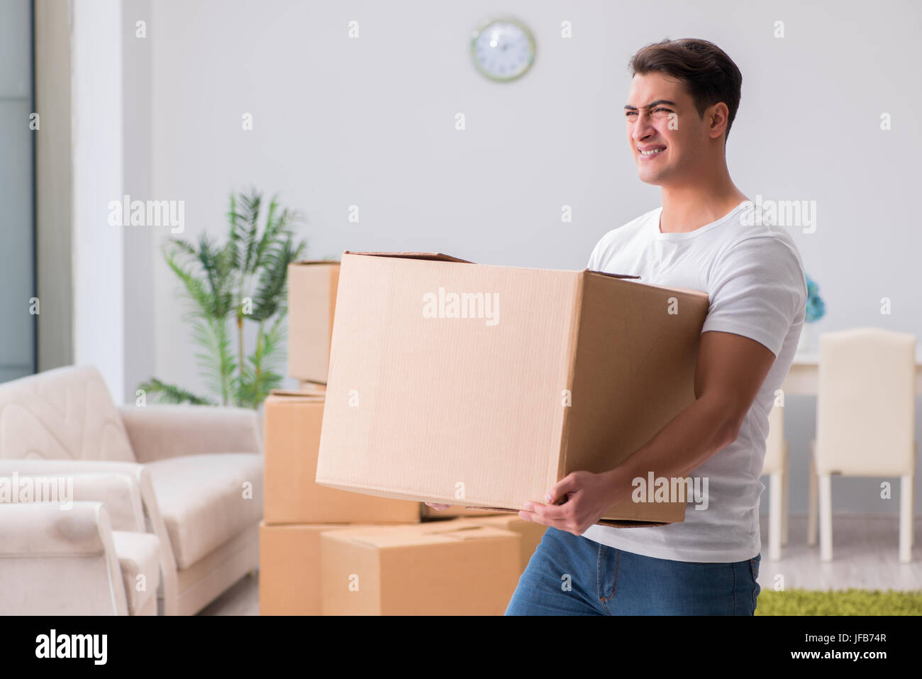 Tired delivery man with box Stock Photo - Alamy