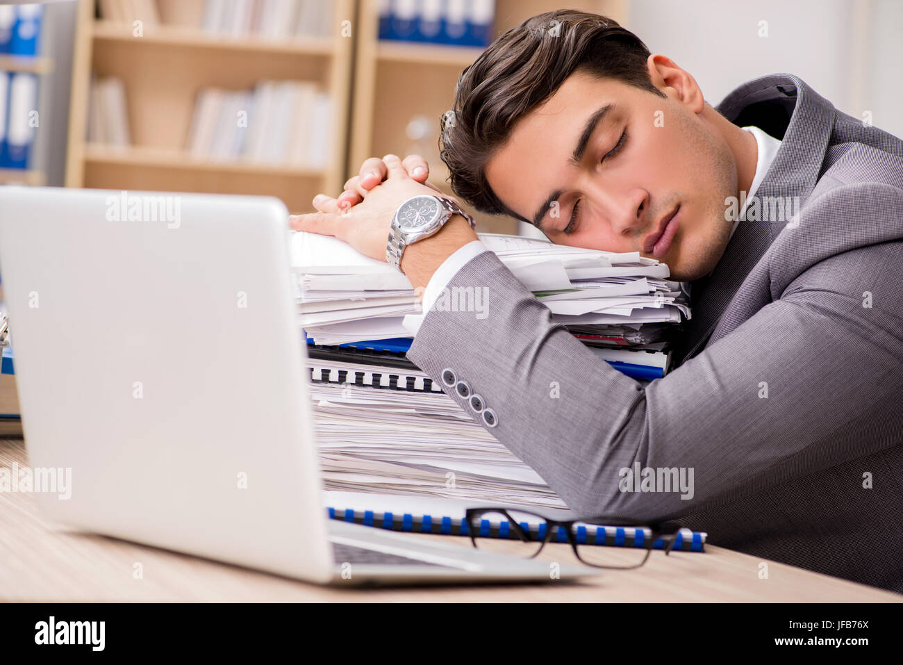 Businessman tired sitting in the office Stock Photo - Alamy