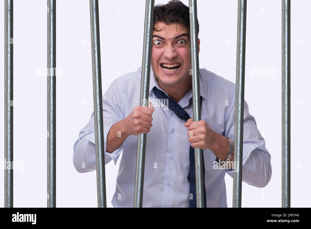 Young businessman behind the bars in prison Stock Photo - Alamy