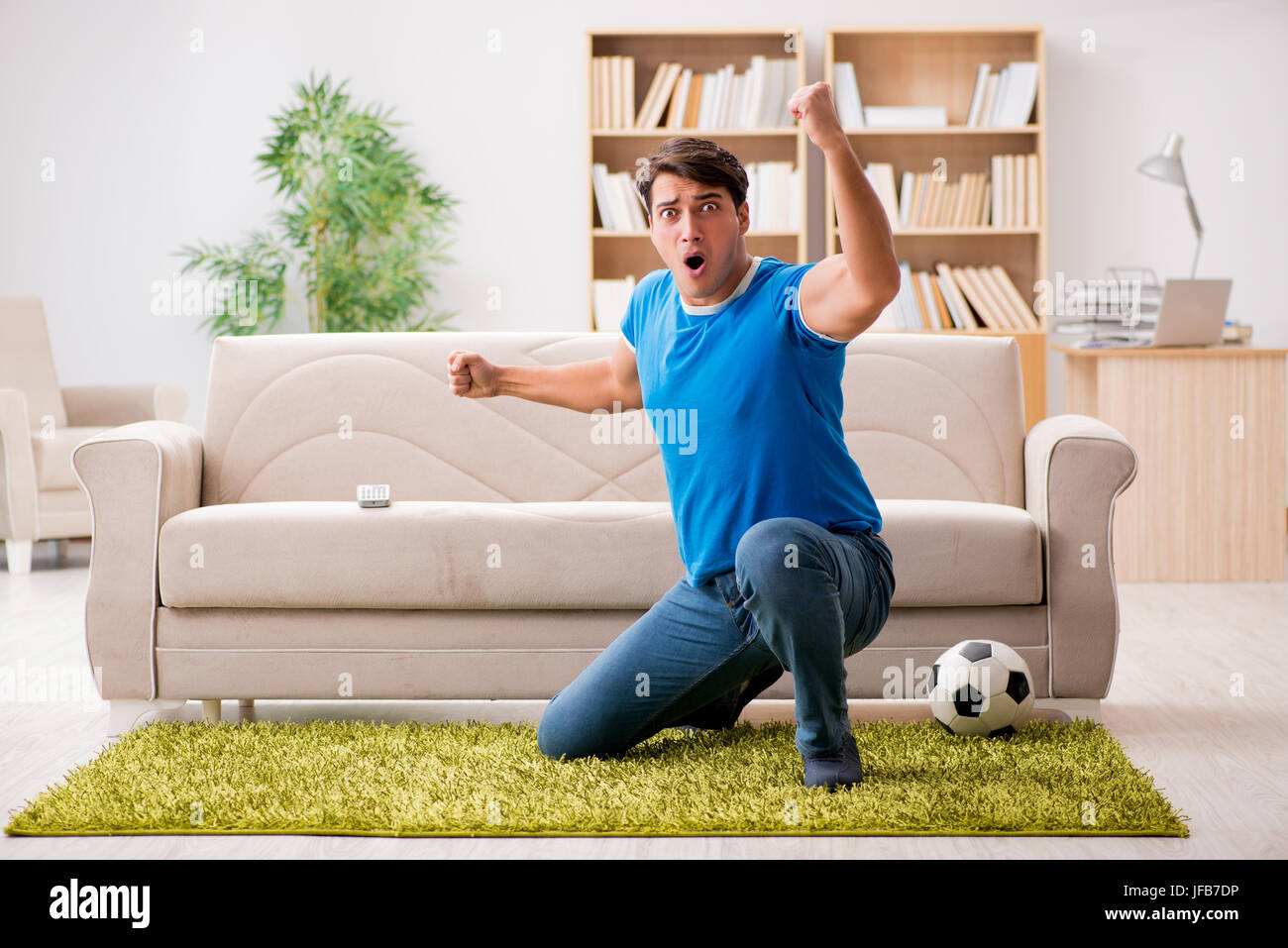 Man watching football at home Stock Photo - Alamy